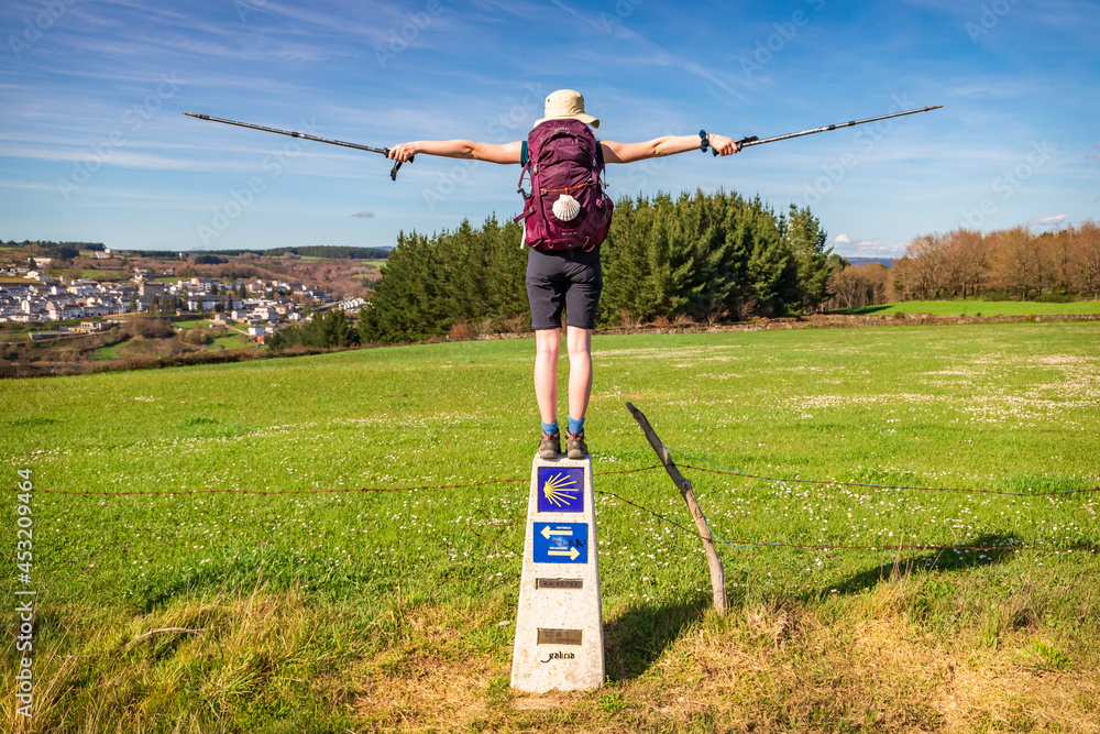 Pilgrim Girl Standing on Two Way Camino de Santiago Mark Post in ...