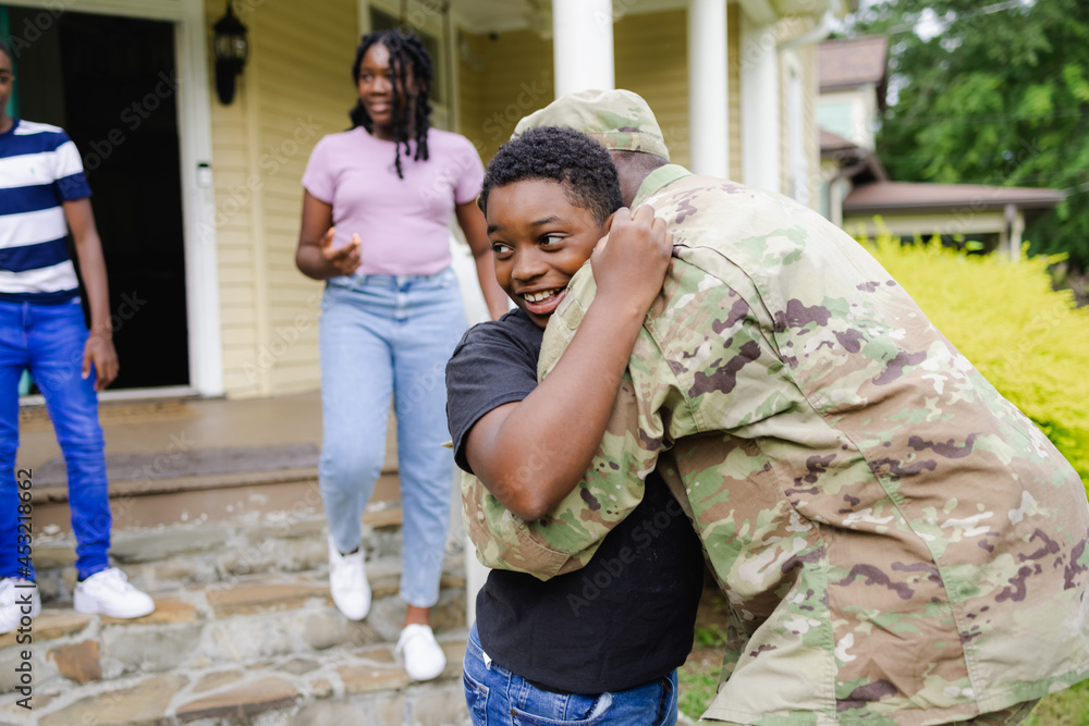 Black military man embraces son as he is welcomed home Stock Photo ...