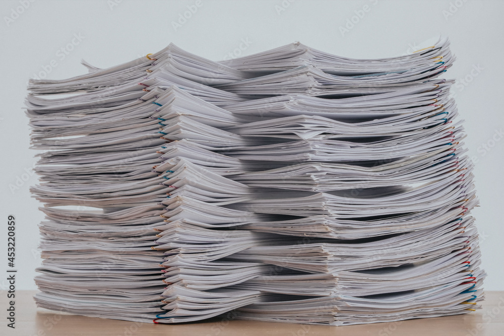 Stack of business paper on wooden desk, job interview and busy business ...