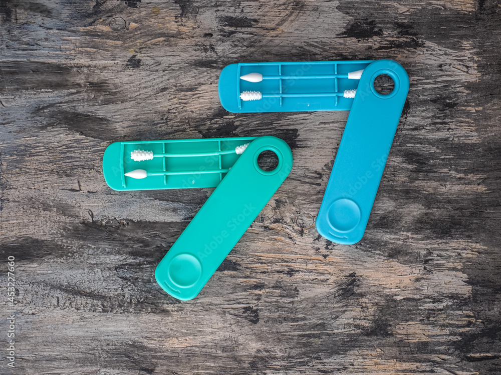 Two sets of silicone sticks for ear care and makeup correction on a ...