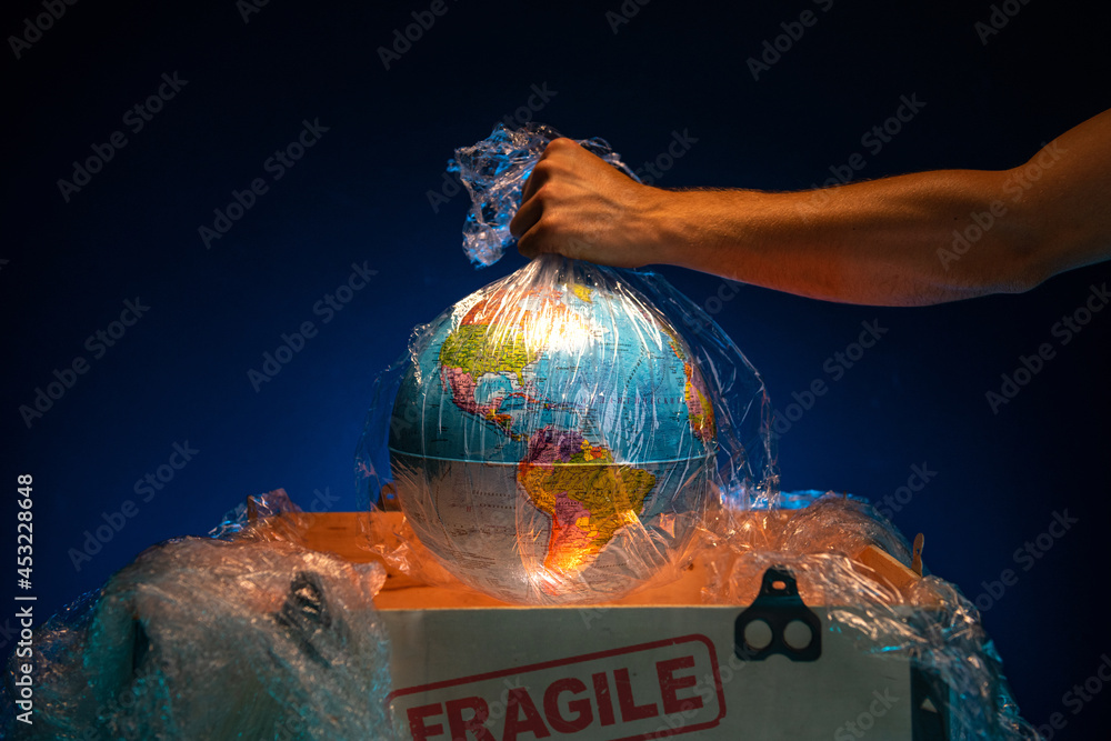 An employee takes a valuable cargo out of a wooden box, a concept for ...