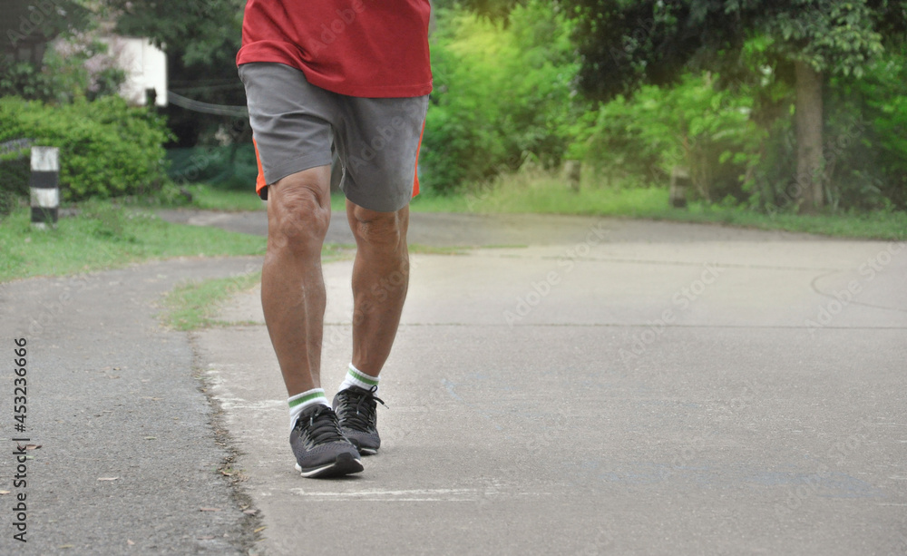 an old man legs and muscles while running along the street, concept ...