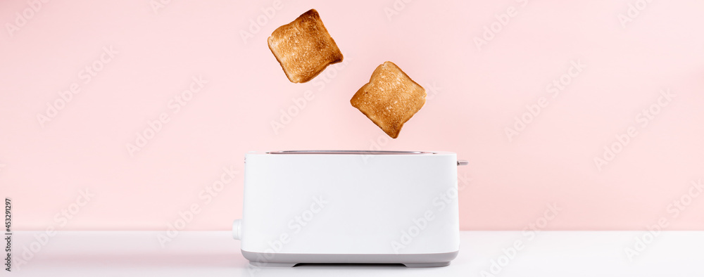 Toasts jumping out of white toaster. Levitation food. Delicious ...