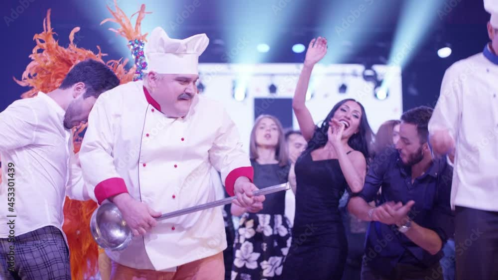 Cook and waiters dancers having fun dancing at a colorful party . Funny ...