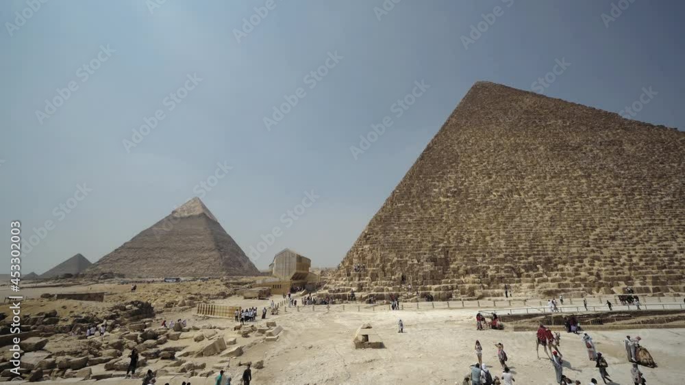 The Great Pyramids of Giza with crowd of tourists and local people with ...
