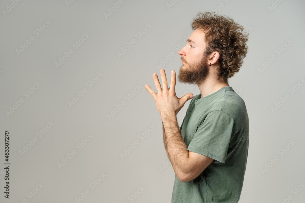 Young handsome man casual sideways pose with palms folded. Handsome ...