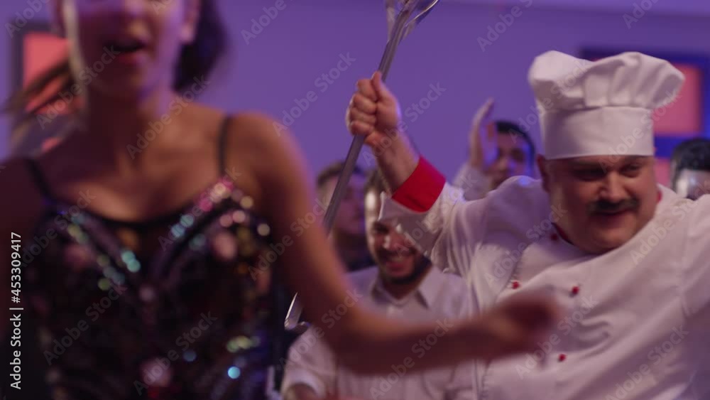 Cook dancers having fun dancing at a colorful party . Funny cook chef ...