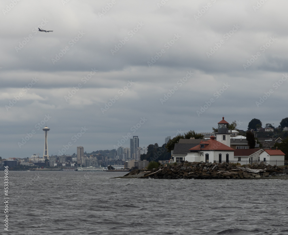 Alki Point Lighthouse as seen from Puget Sound with the Space Needle in ...