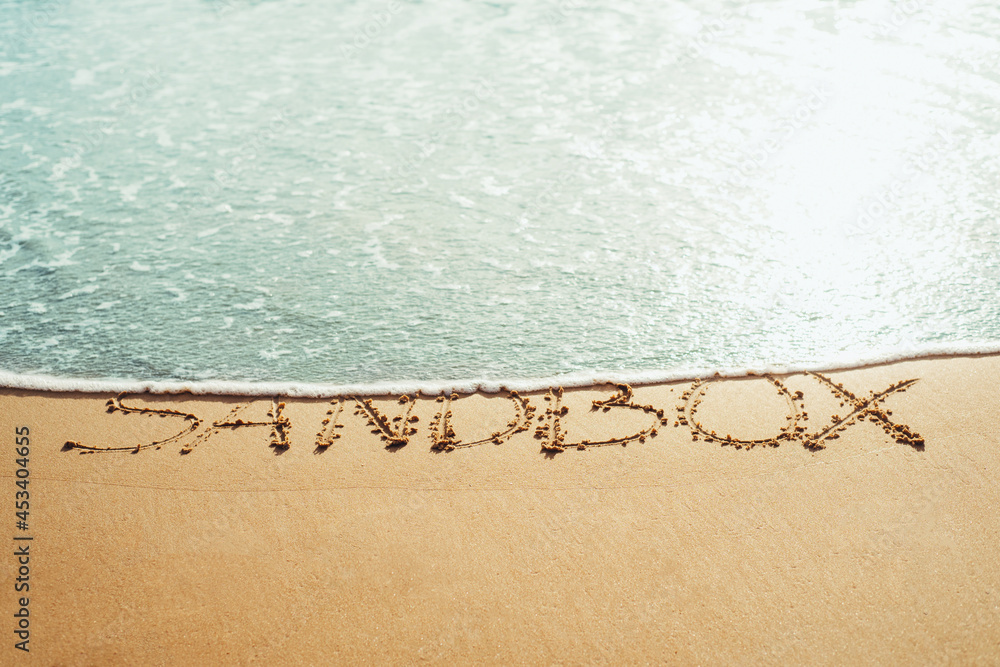 Sandbox text written in the sand on the beach in Phuket, Thailand with ...