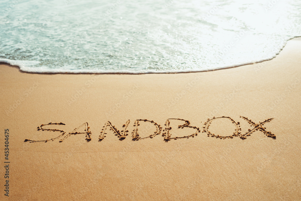 Sandbox text written in the sand on the beach in Phuket, Thailand with ...
