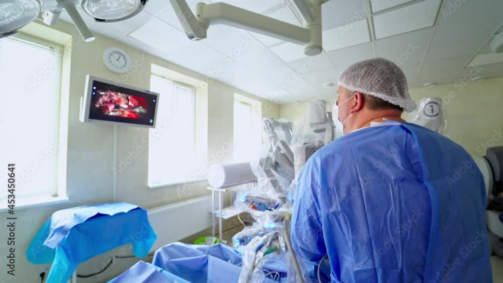 Stockvideon Doctor perform robotic surgery and looking on a screen ...