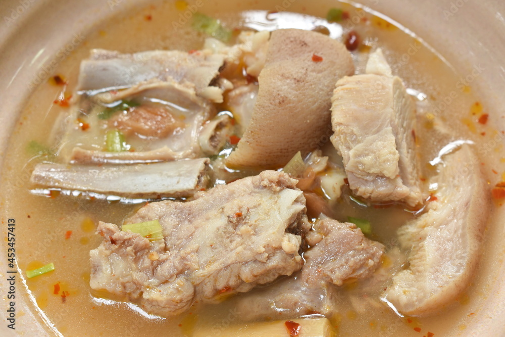 hot and spicy pork bone with tamarind and Thai herbs soup on bowl ...