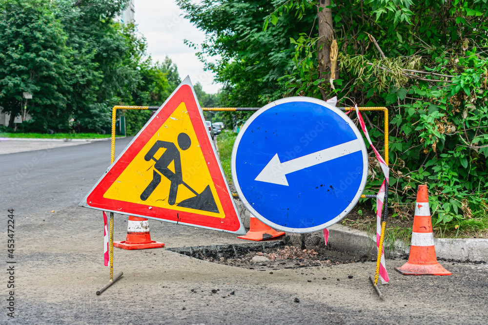 Road signs indicating the repair of asphalt and the direction to bypass ...