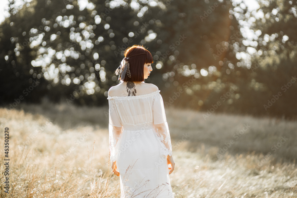 Back portrait of native indian american woman, in white boho dress ...