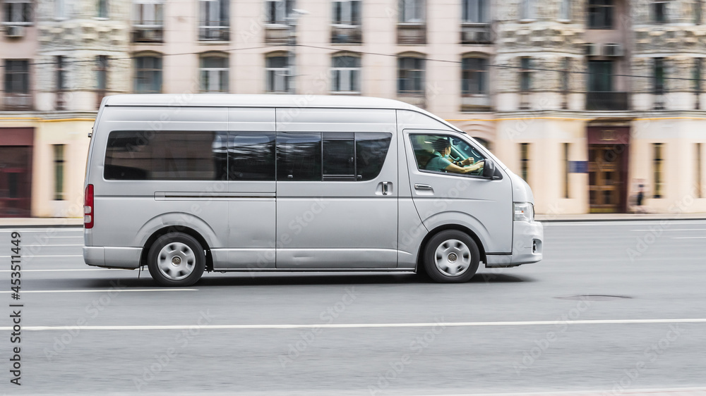 Silver Toyota HiAce LWB van at the city street, side view. Fifth ...