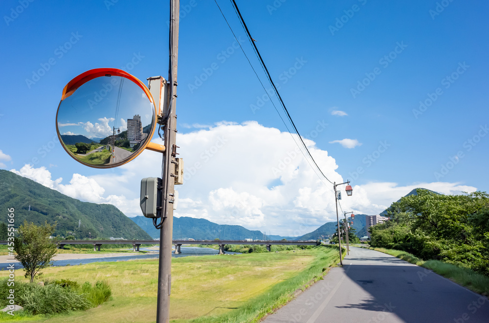 standing traffic mirror on the chikuma river side road in nagano ...