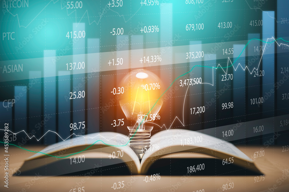 Light bulb and opened vintage book style vintage dark background ...