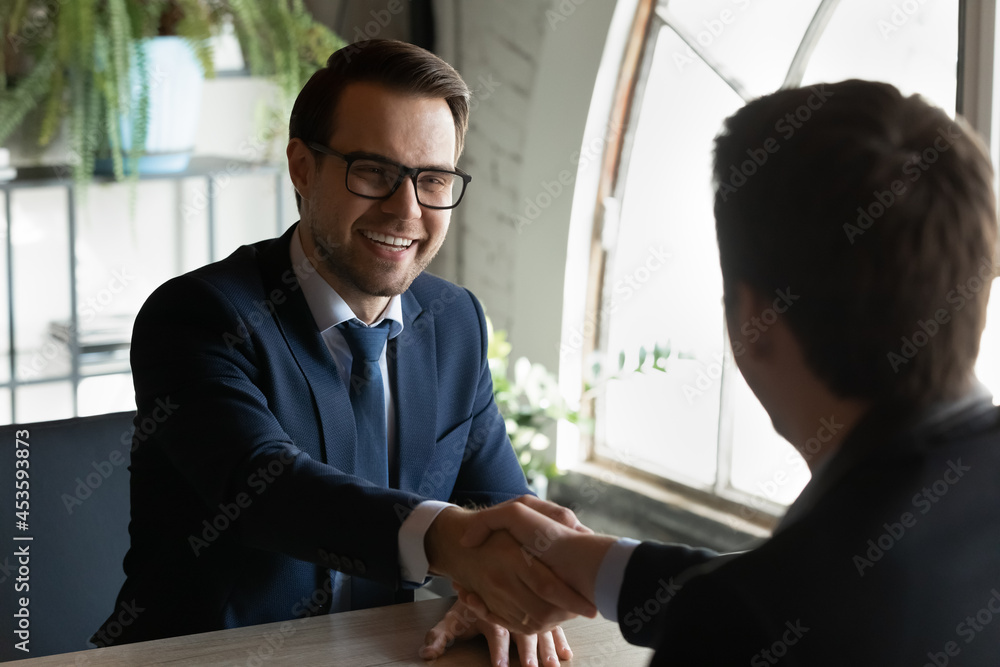 Recruiter hr manager shaking excited candidate hand, greeting at job ...