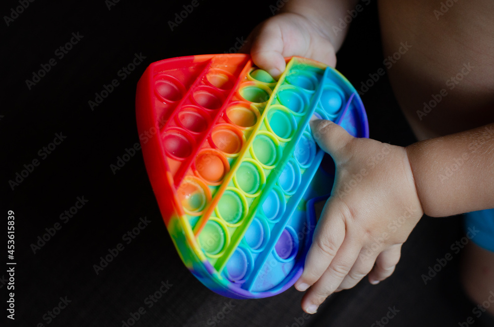 Popit toy, simple dimple rainbow colors, in the form of a heart ...
