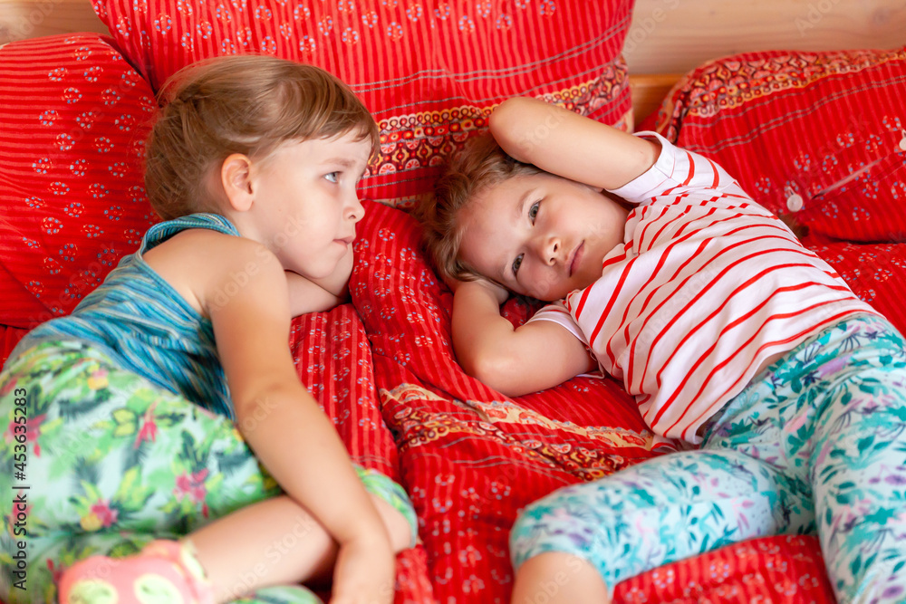 Two little school age girls, healthy young tired exhausted children ...