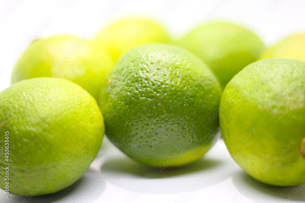 bunch of lemons on white background, green fruit on white background ...