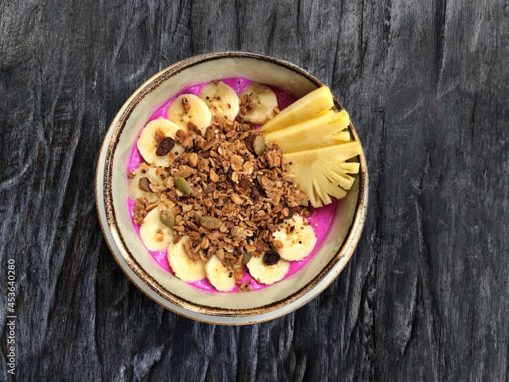 Pitaya breakfast bowl. White rustic black wooden background. Acai ...