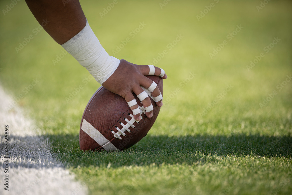 Hiking the football in a football game. Focus on the hands and the ...