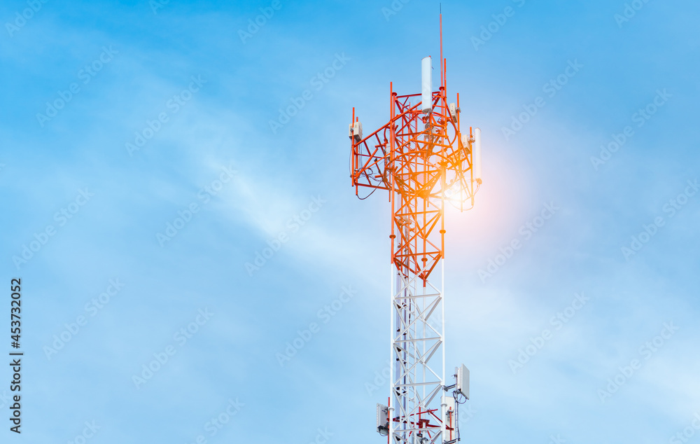 Telecommunication tower with blue sky and white clouds background. Antenna on blue sky. Radio ...