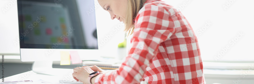 Hunched woman typing on computer keyboard at table Stock Photo | Adobe ...