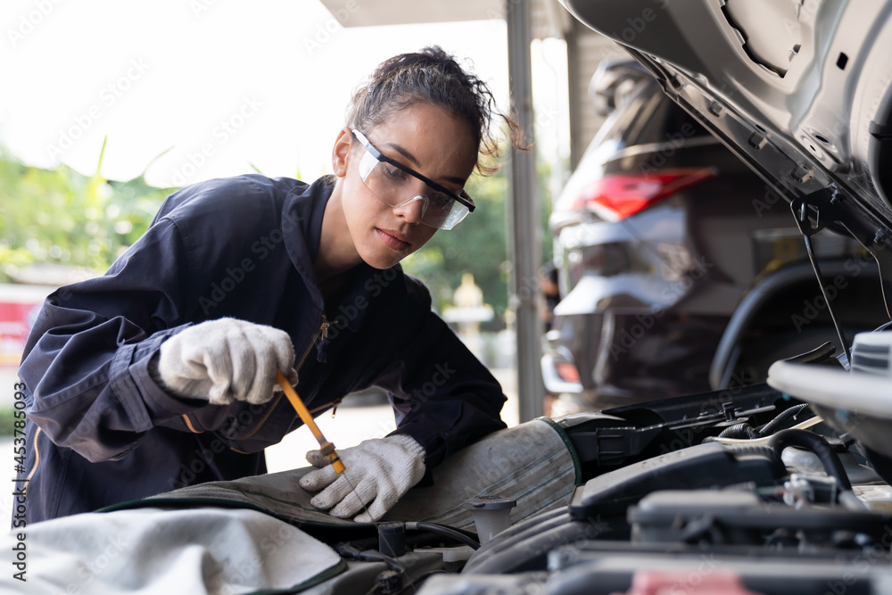 Female mechanic working at the garage. Professional female car mechanic ...