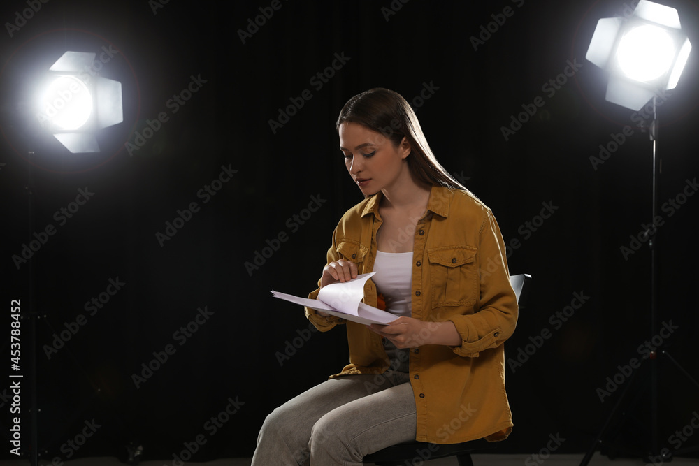 Professional actress reading her script during rehearsal in theatre ...