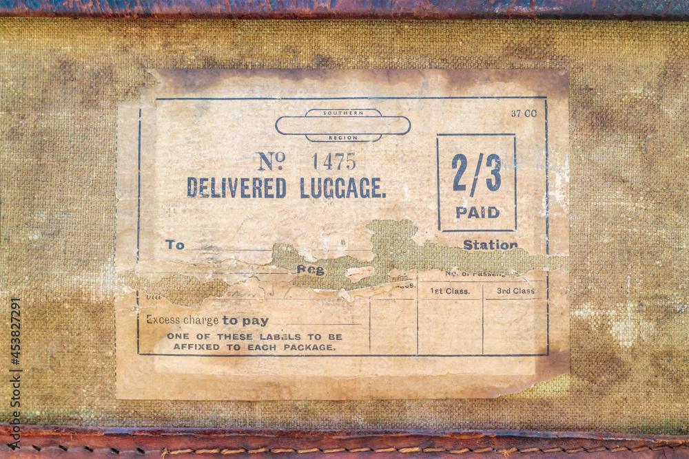 Vintage torn paper luggage label with text delivered luggage on an old ...