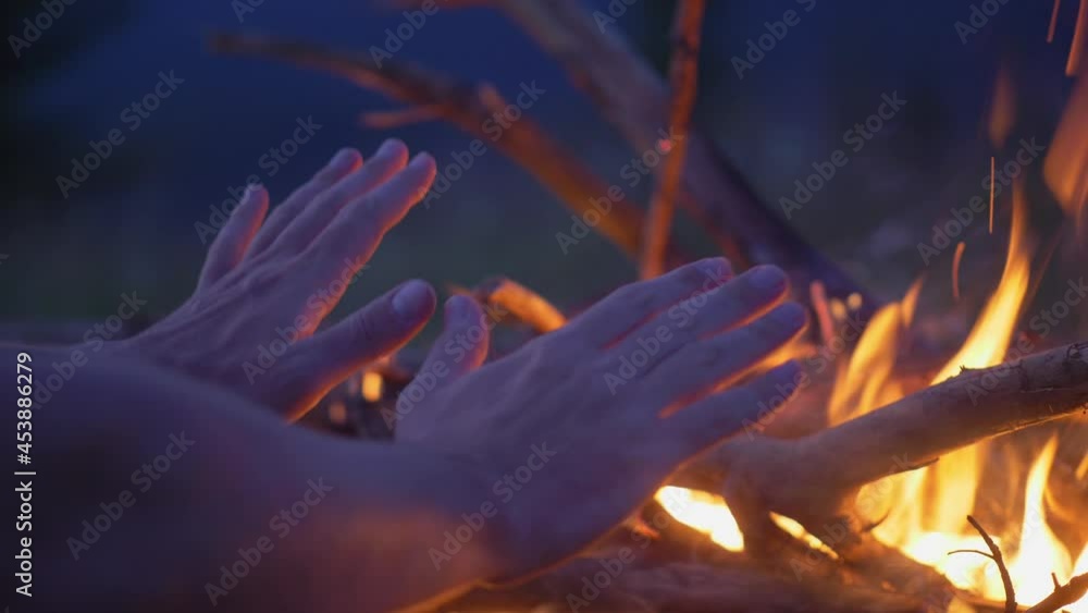 campfire in the forest, rubbing hands over the fire, hiking, tourism ...