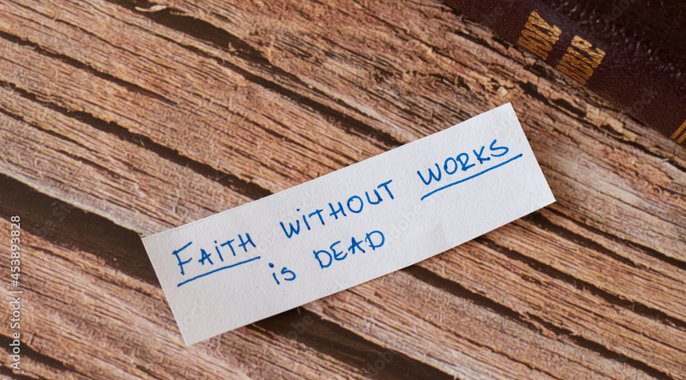 Faith without works (deeds) is dead. Closeup of handwritten Bible verse ...