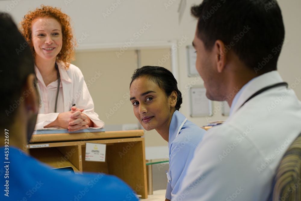 Hospital staff talking at front desk Stock Photo | Adobe Stock