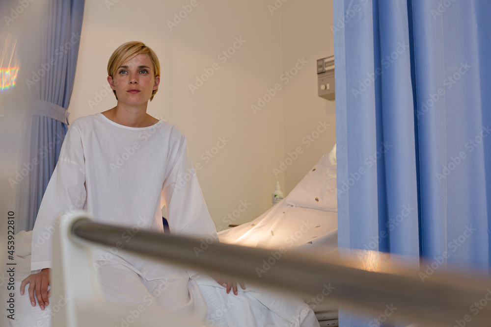 Patient wearing gown on hospital bed Stock Photo | Adobe Stock