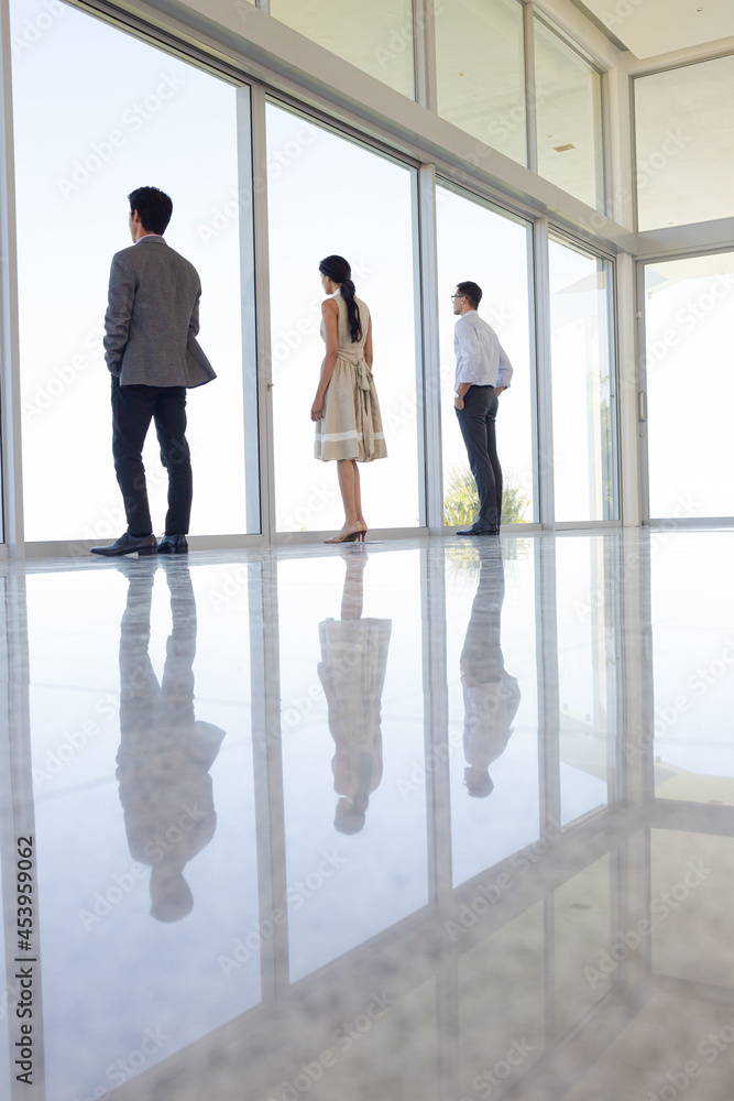 Business people standing at window Stock Photo | Adobe Stock