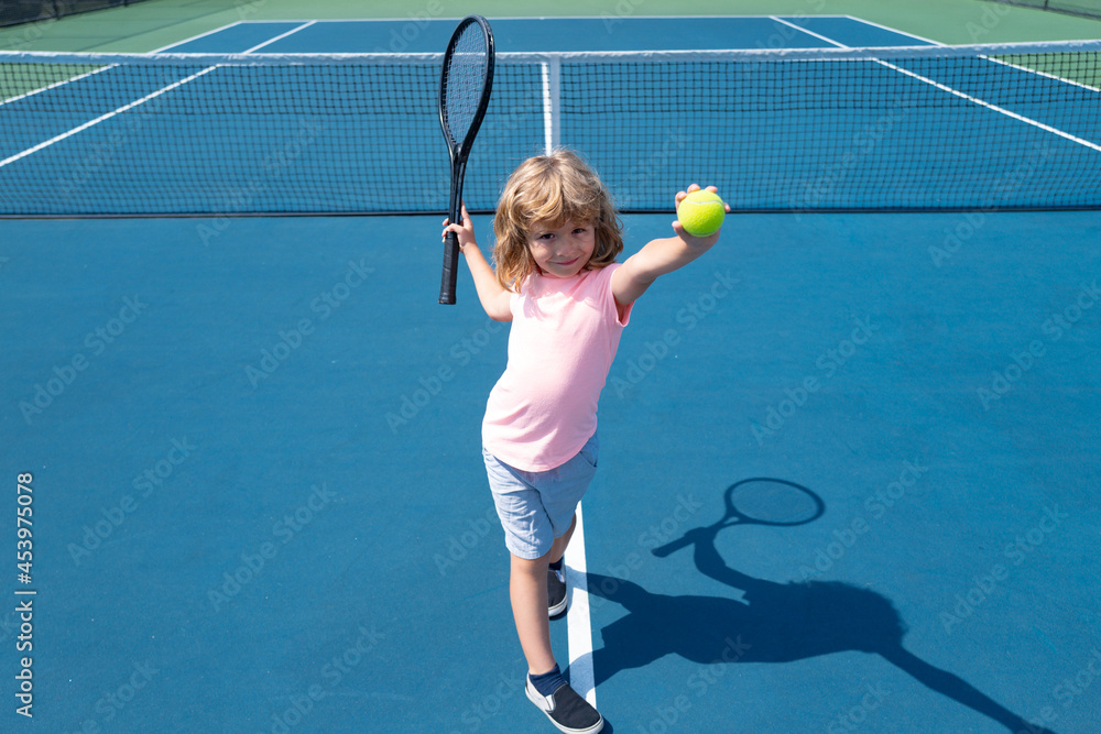 Child boy playing tennis on outdoor court. Little girl with tennis ...