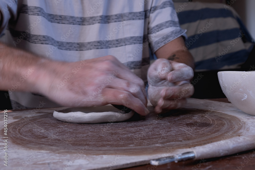 Vertical photo of dirty hands working with clay Stock Photo | Adobe Stock