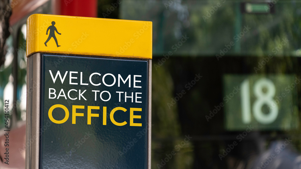 Welcome back to the office sign in a busy commuter city center Stock ...