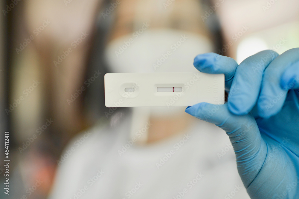 Asian doctor wearing blue gloves and hygiene protective face mask ...