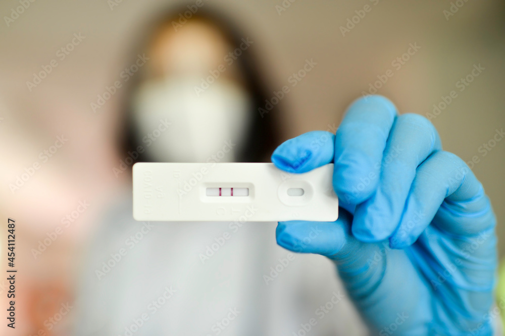 Asian doctor wearing blue gloves and hygiene protective face mask ...