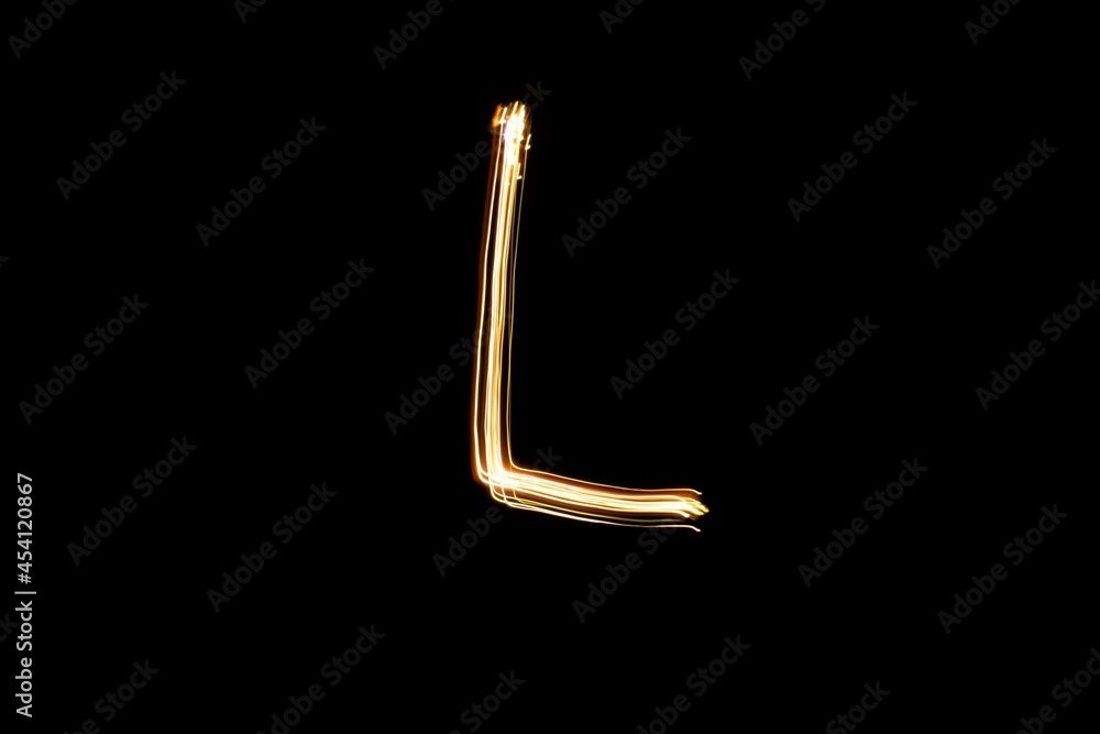 Drawn letter L with gold lights against black background. Light ...