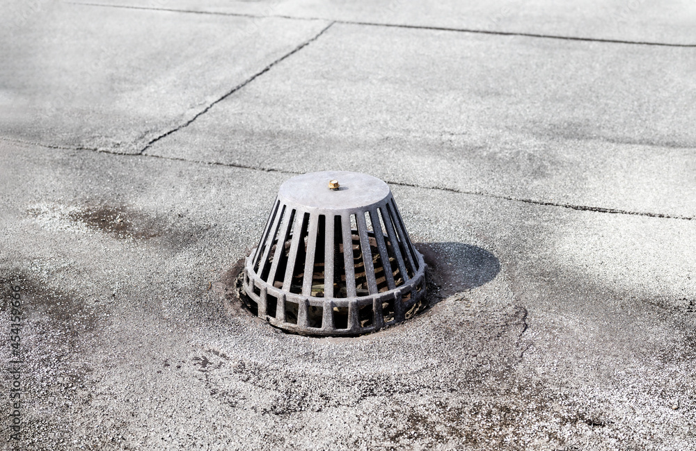 Caged roof drain on flat roof with exposed modified bitumen membrane ...