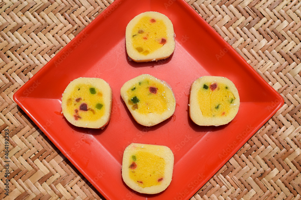 Indian sweet dish Tutti fruity Barfi rolls. With tutti frutti kesar ...