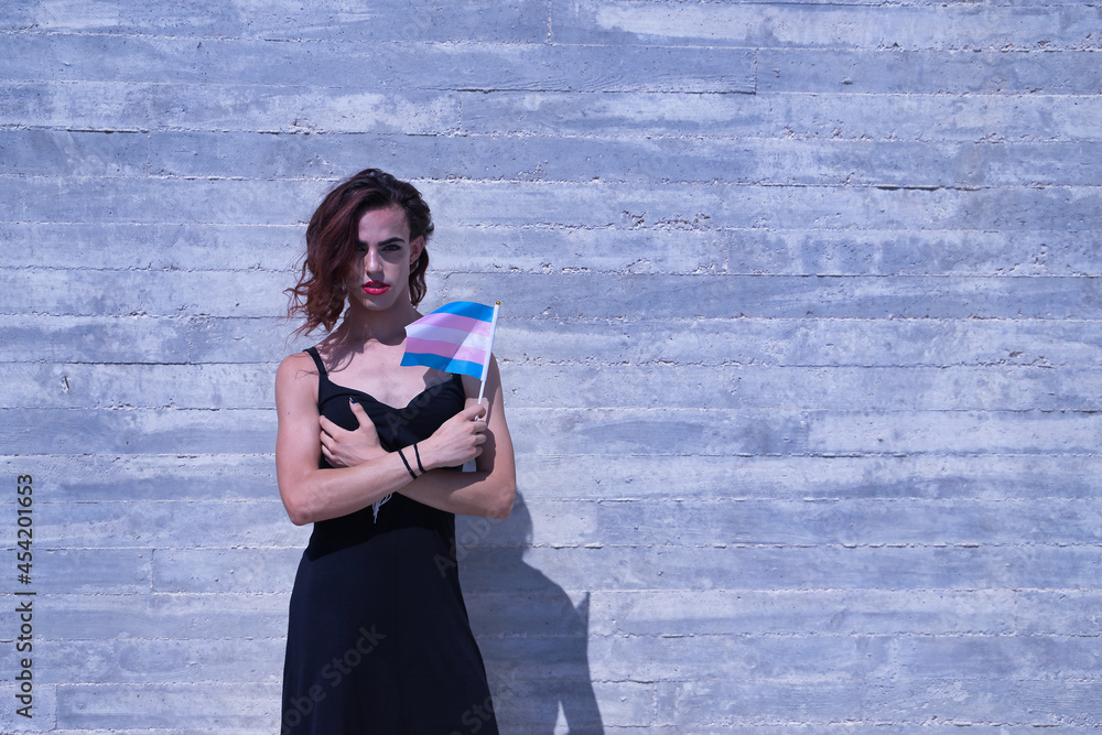 Foto de Young Hispanic and transgender adult girl with her arms crossed ...