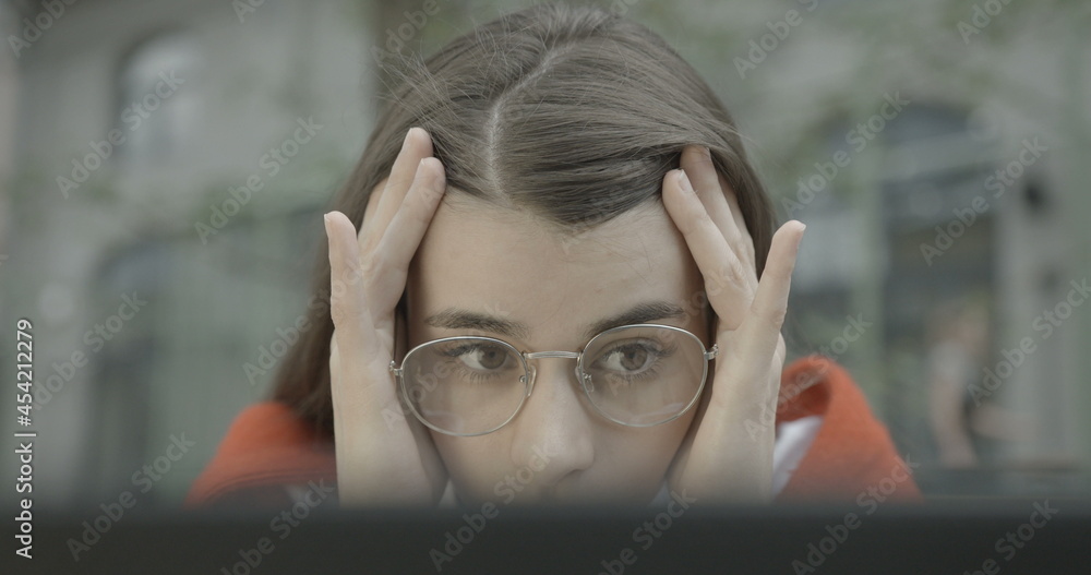 Overwhelmed upset girl is worried because of work or study. She is ...