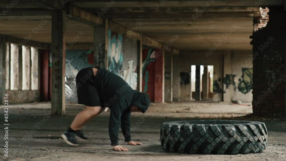 Strong Muscular Man jumps on a Tire as Part of His Bodybuilding/ Cross ...