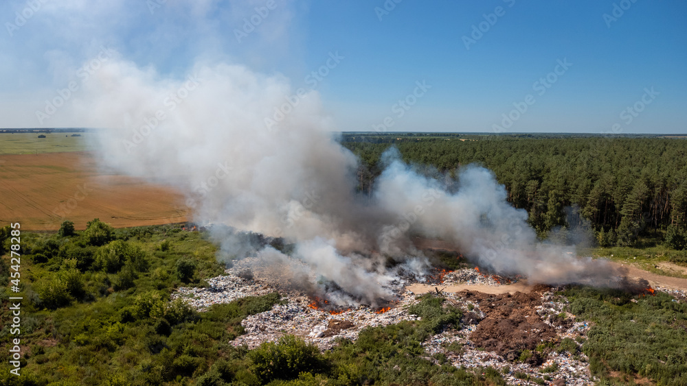 Drone photo of different rubbish including toxic plastic burning at ...