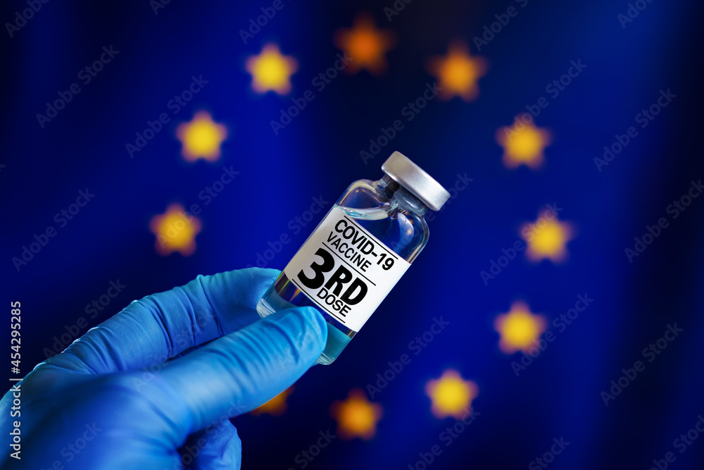 Doctor with a vial with 3rd dose of the vaccine for covid-19 or ...